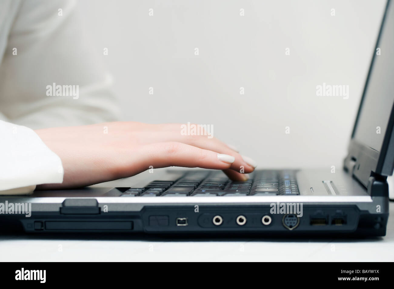 Female hand working on the laptop Stock Photo - Alamy