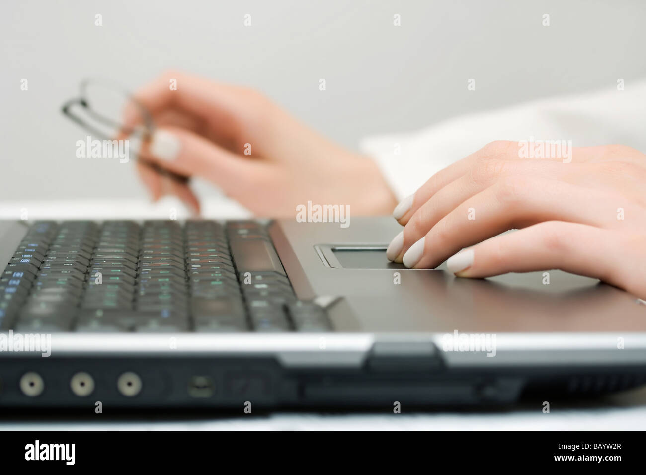 Female hand working on the laptop Stock Photo - Alamy