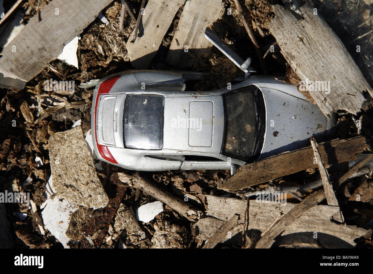 old damaged porsche type green toy sports car in rubbish tip Stock ...
