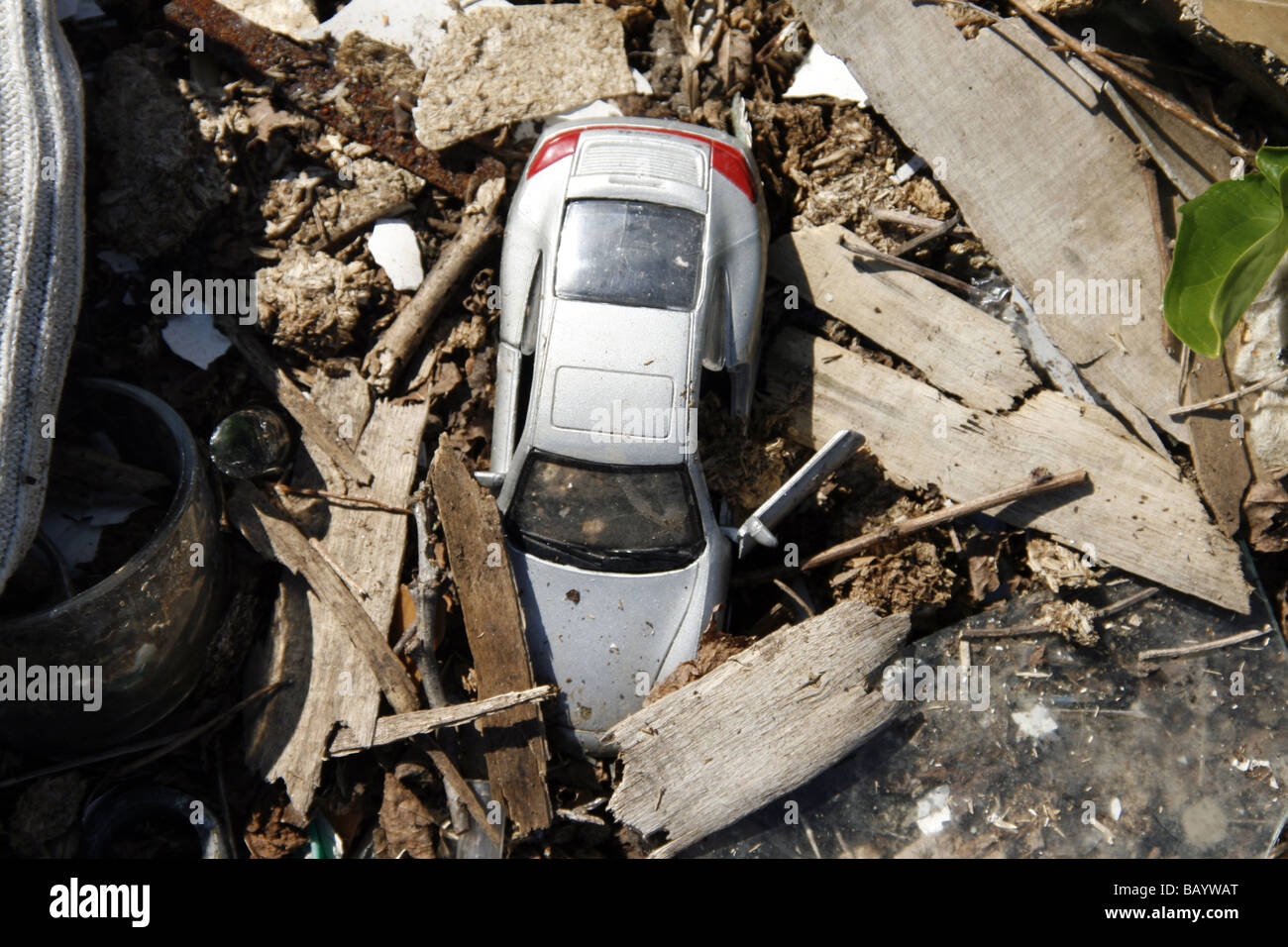 old damaged porsche type green toy sports car in rubbish tip Stock ...