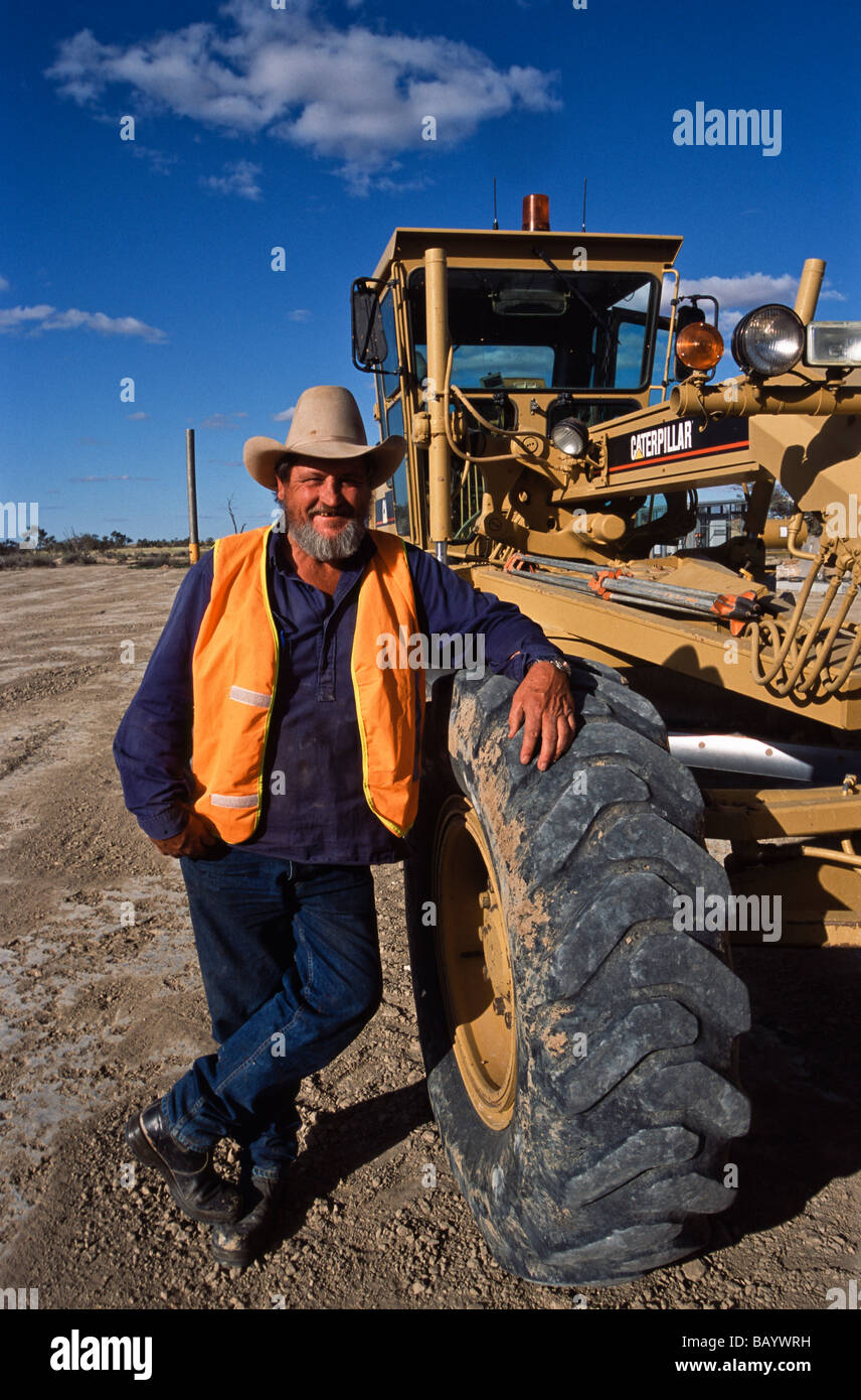 Man and road grader, outback Australia Stock Photo - Alamy