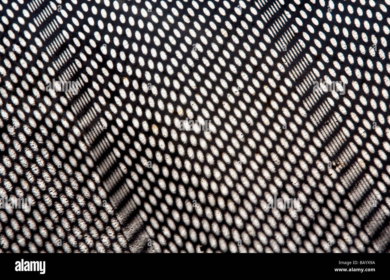 Perforated mesh shadow on concrete floor Stock Photo - Alamy