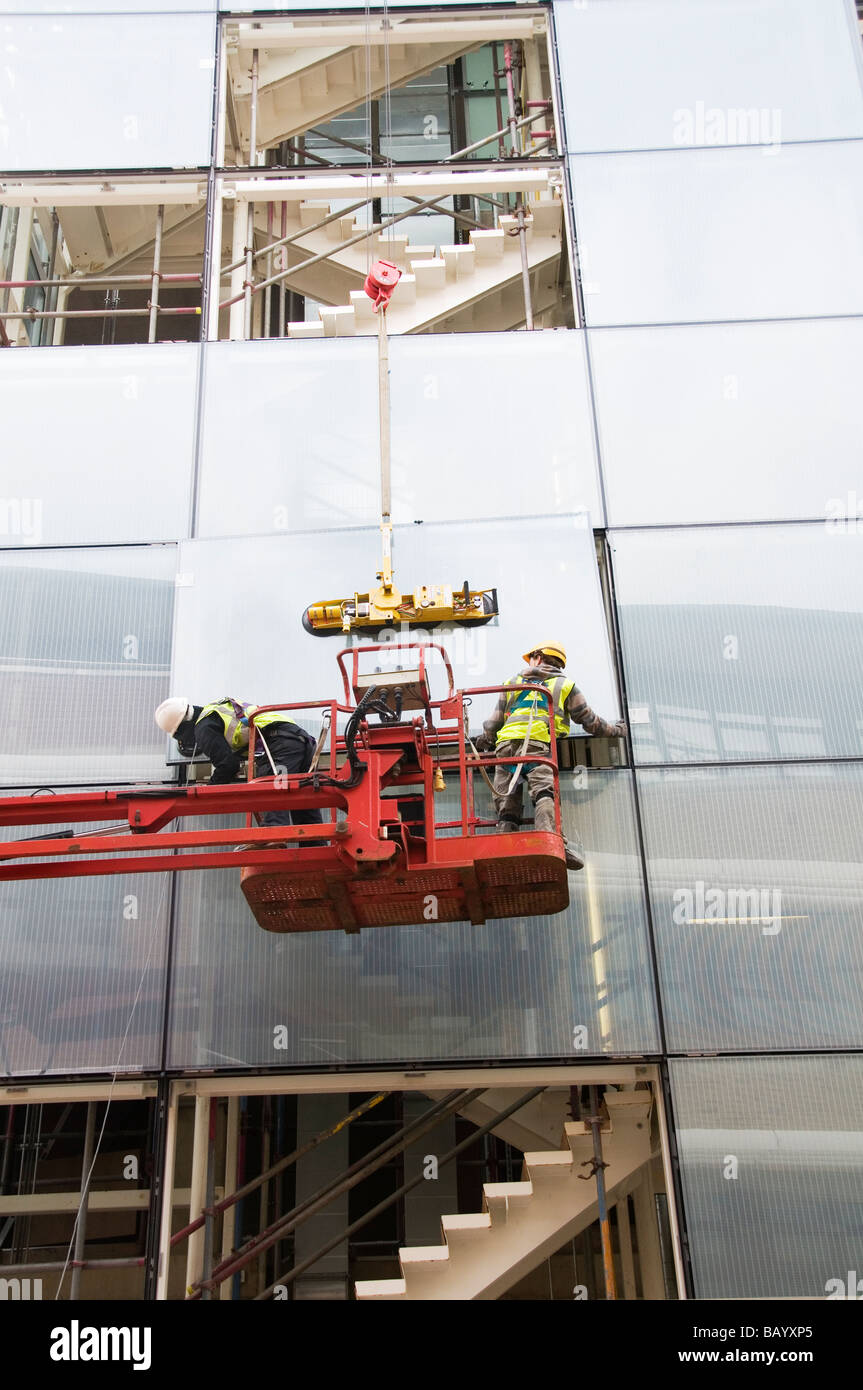Construction workers installing new windows window hi-res stock ...