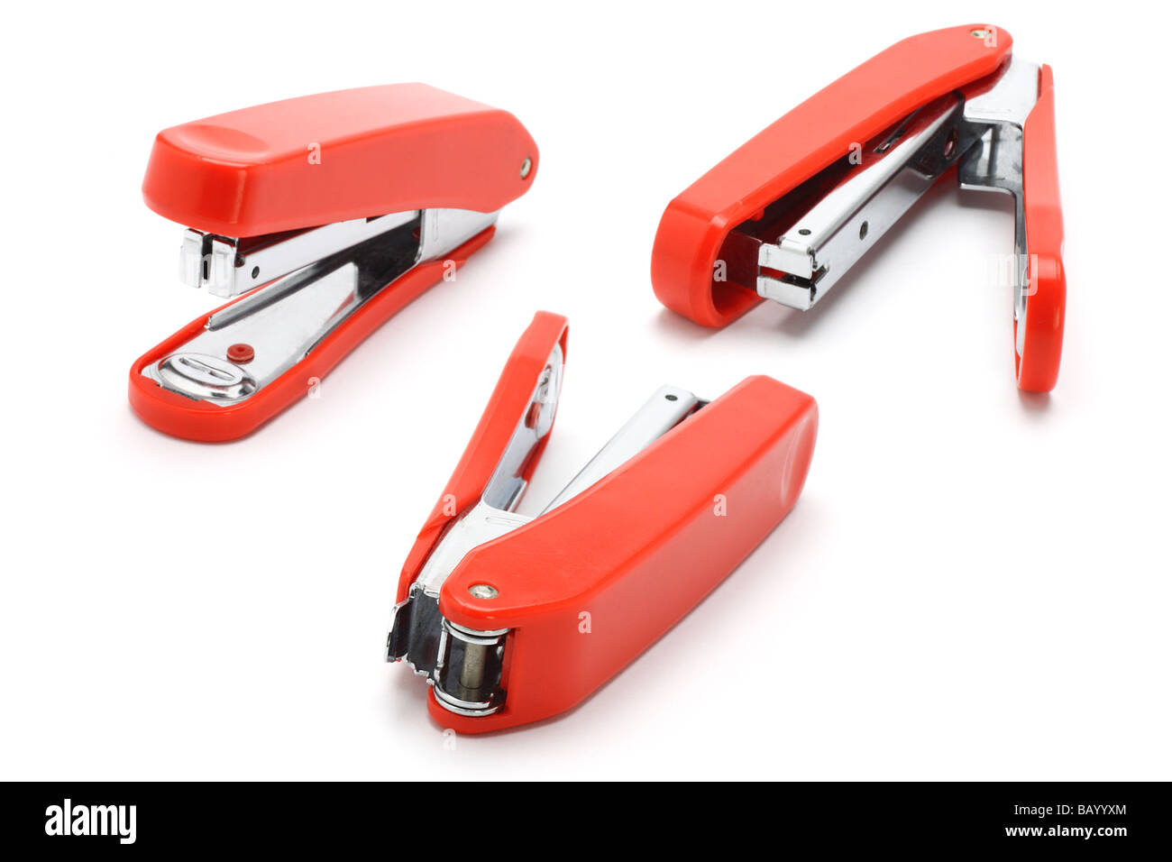 Three orange color staplers arranged on white background Stock Photo ...