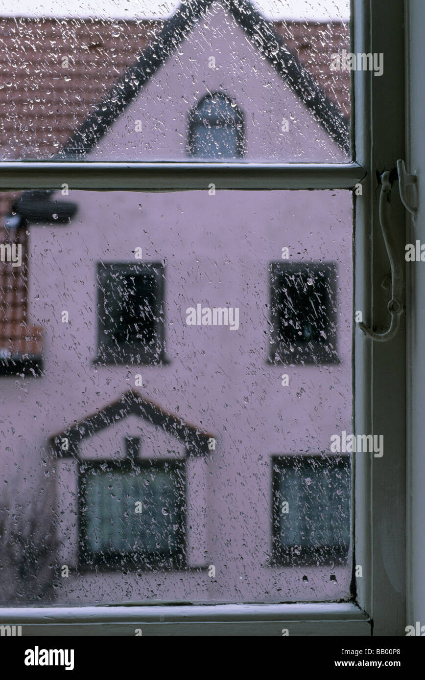 View of house through a window with raindrops Stock Photo - Alamy