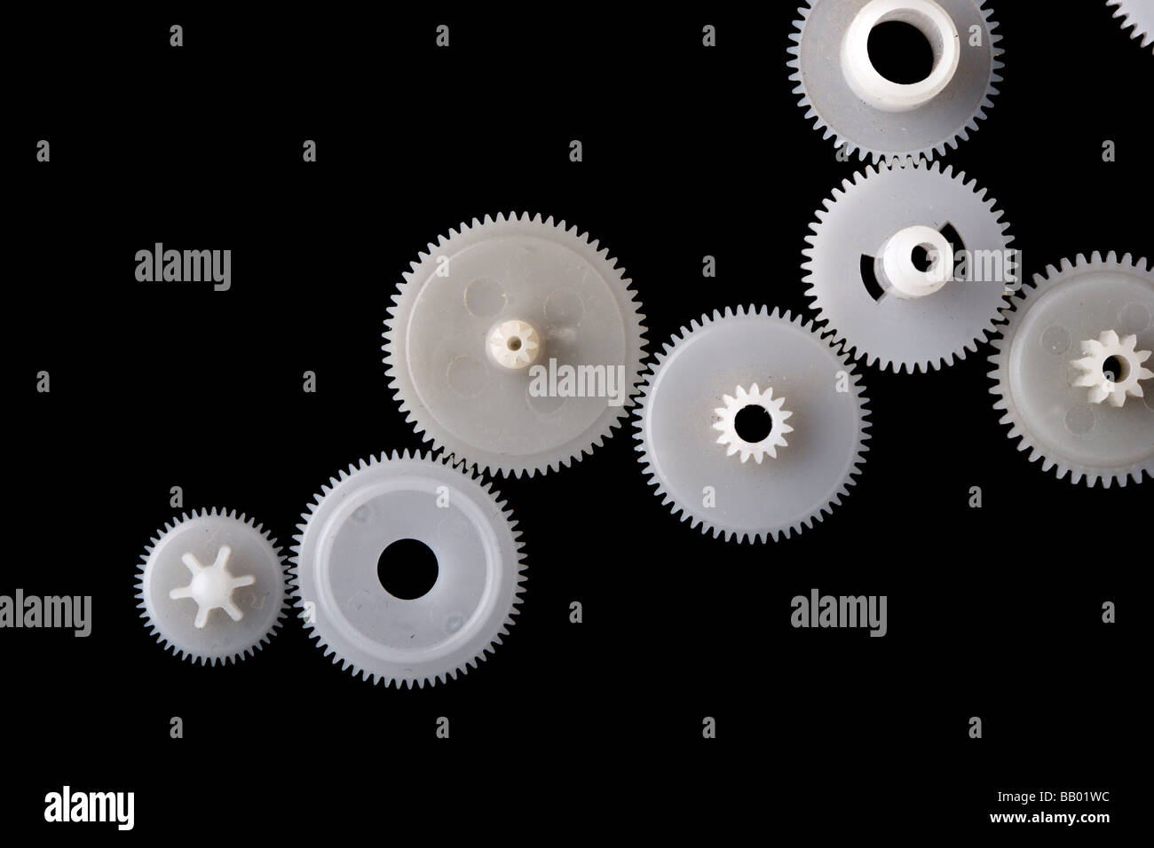 set of gears isolated on black background Stock Photo - Alamy