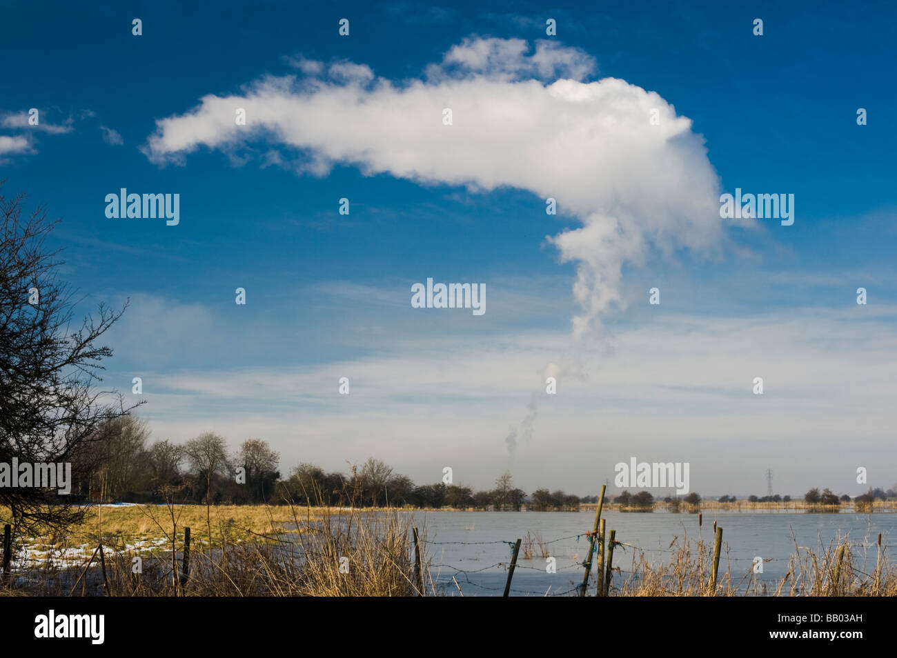 Flooded River Nene Washes, Whittlesey, Cambridgeshire, with steam plume ...