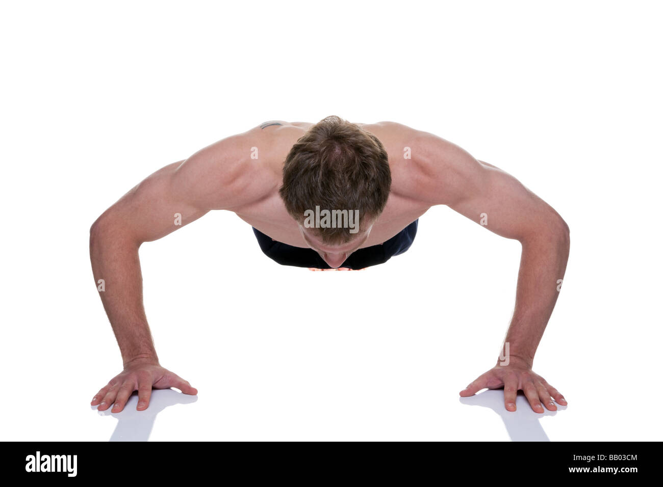 Man doing a press up isolated on a white background Stock Photo - Alamy