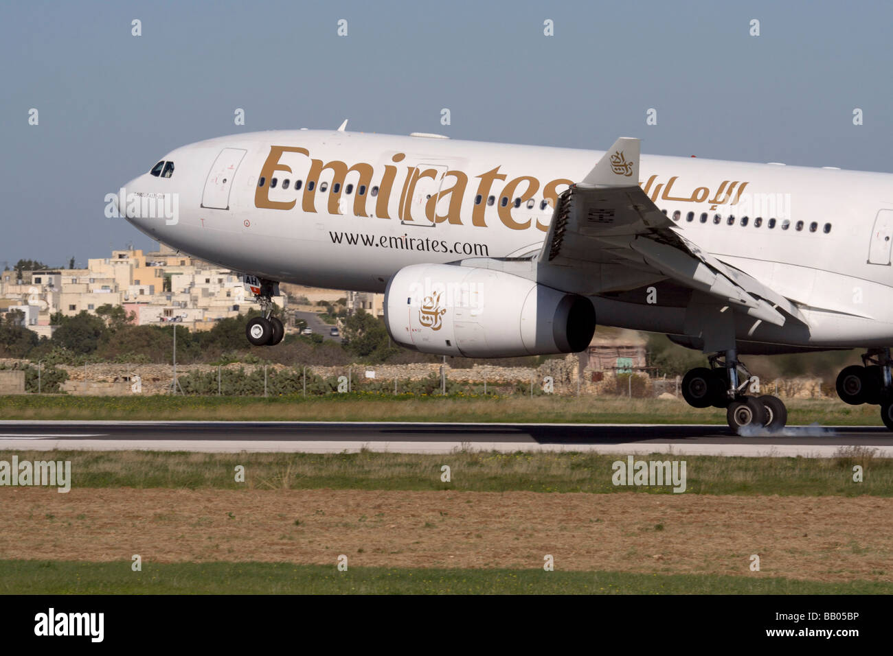 Emirates Airbus A330-200 passenger jet plane at the moment of touchdown ...