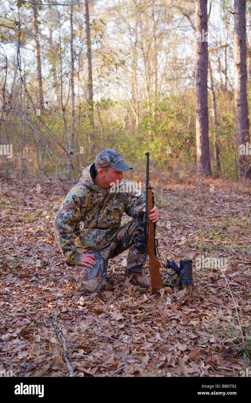 HUNTER KNEELING DOWN LOOKING LISTENING WATCHING FOR GAME IN GEORGIA ...