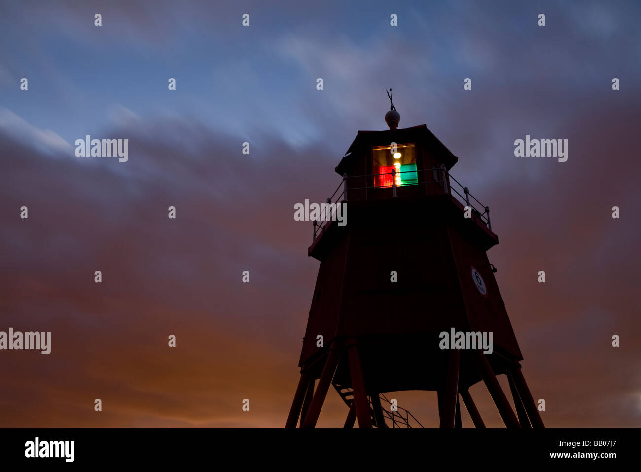 Lighthouse with clouds moving behind it Stock Photo - Alamy