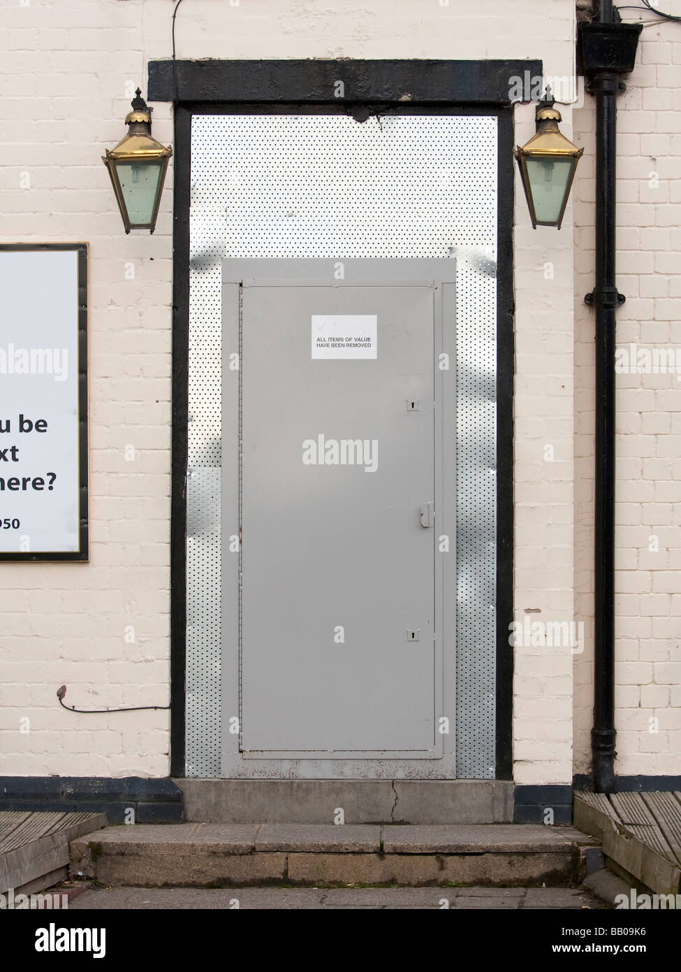 boarded up and secured front door of a closed public house (pub) in ...