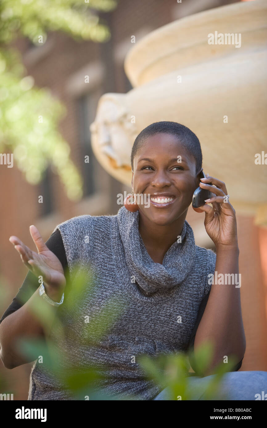 African woman talking on cell phone outdoors Stock Photo - Alamy