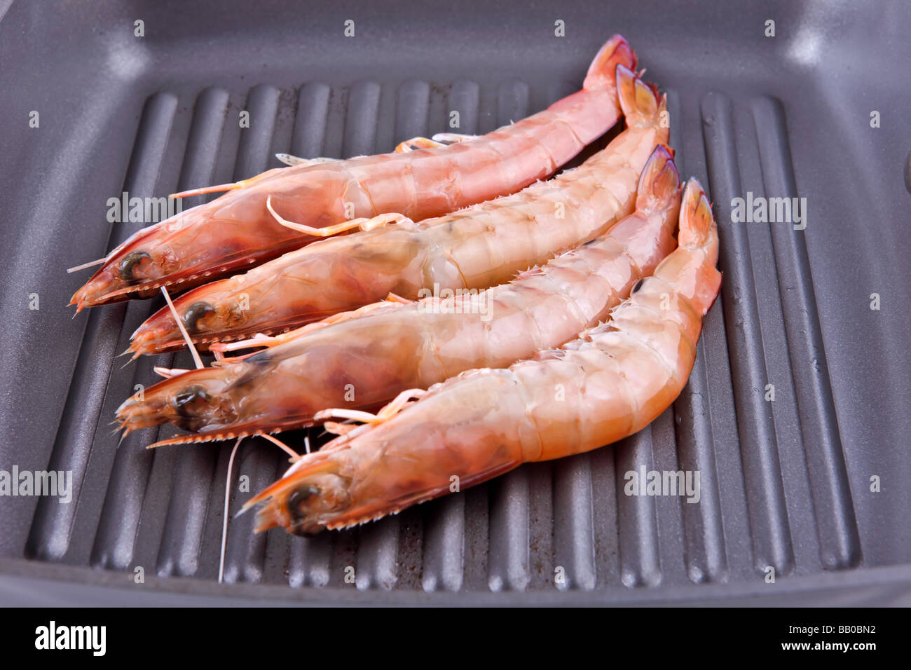 Raw green prawns ready to be cooked on a skillet Stock Photo - Alamy