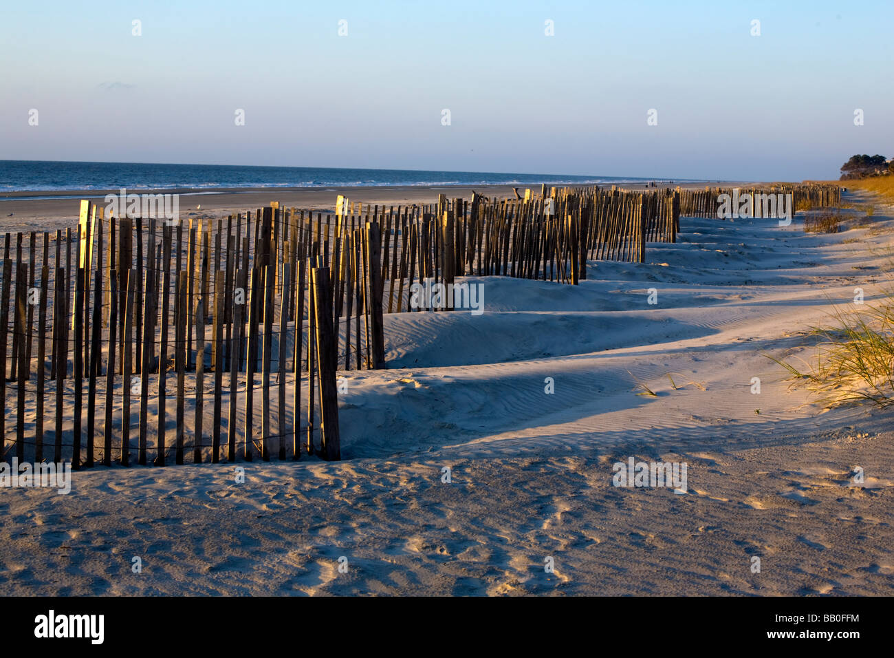Fence in sand dunes Stock Photo - Alamy