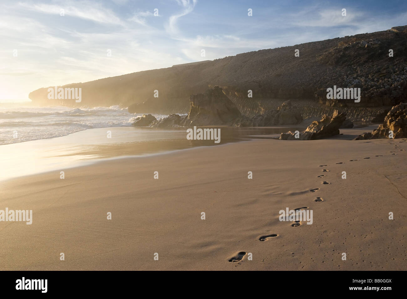 chain of footprints on sand of ocean beach Stock Photo - Alamy