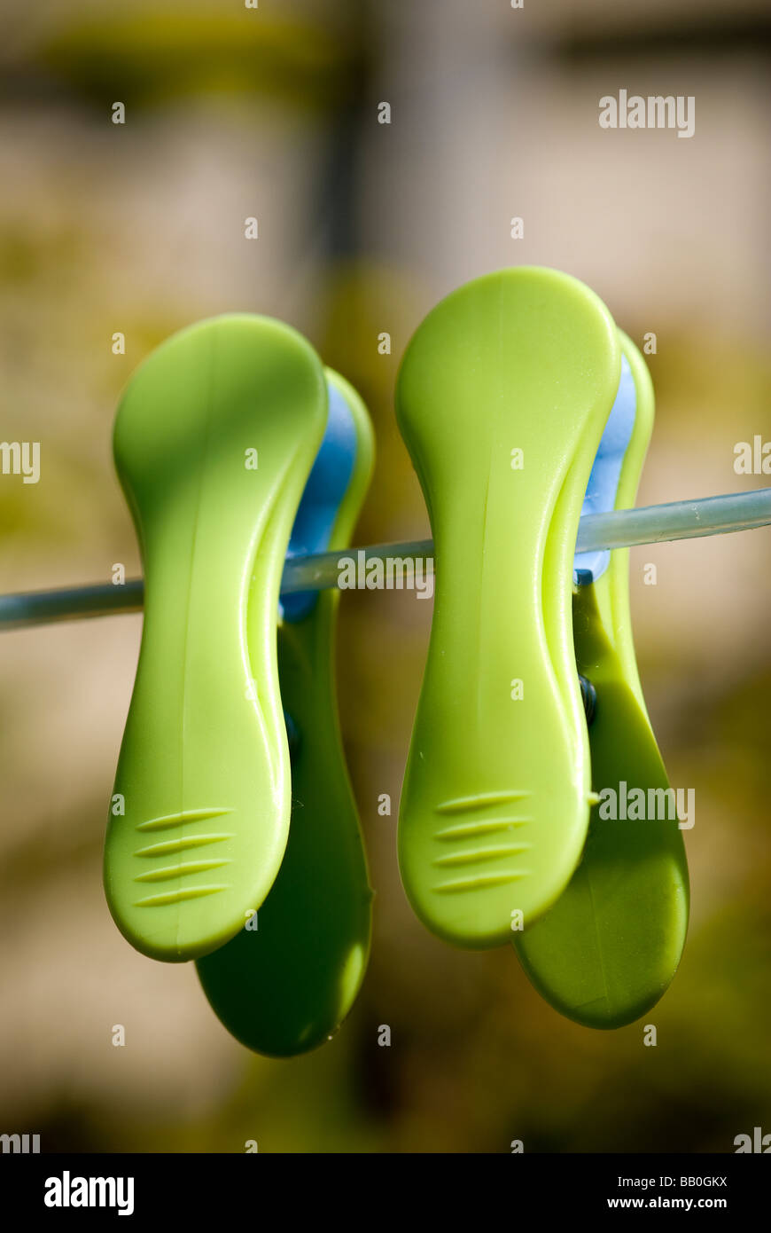 Green plastic washing pegs on a washing line Stock Photo - Alamy