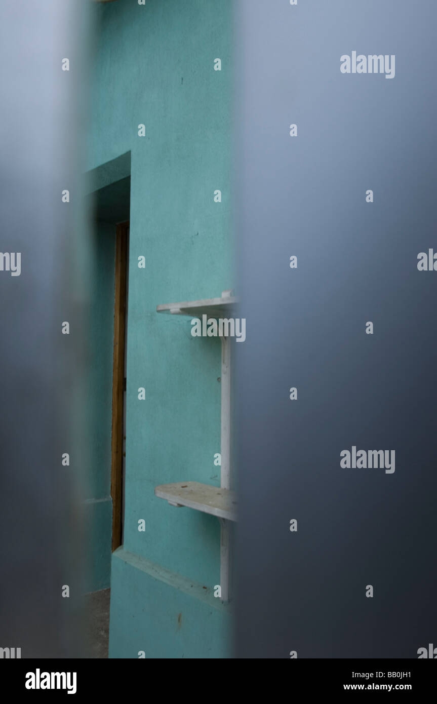 sneaky look through a broken door frame to whats inside Stock Photo - Alamy
