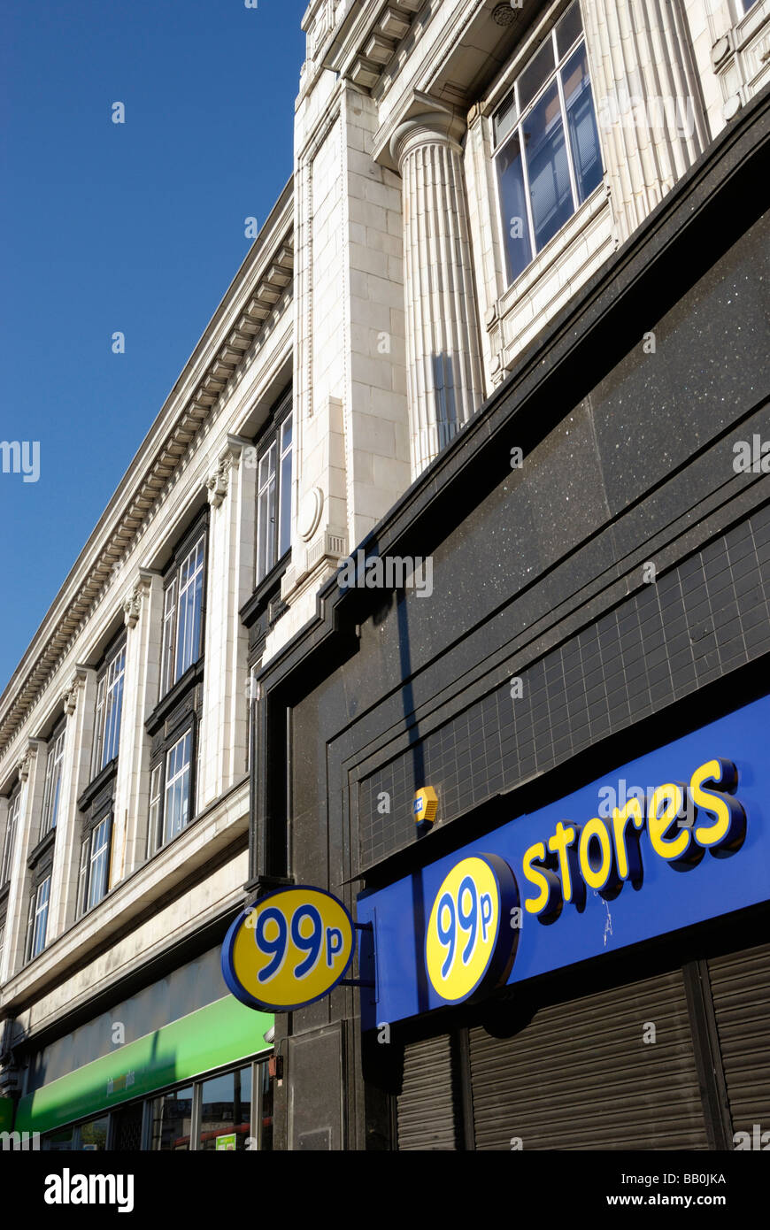 99p Stores sign below ornate classical Victorian building facade Stock ...