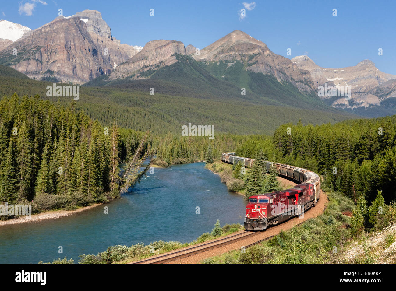 Train and railway with mountain scenery: A Canadian Pacific diesel locomotive transporting ...