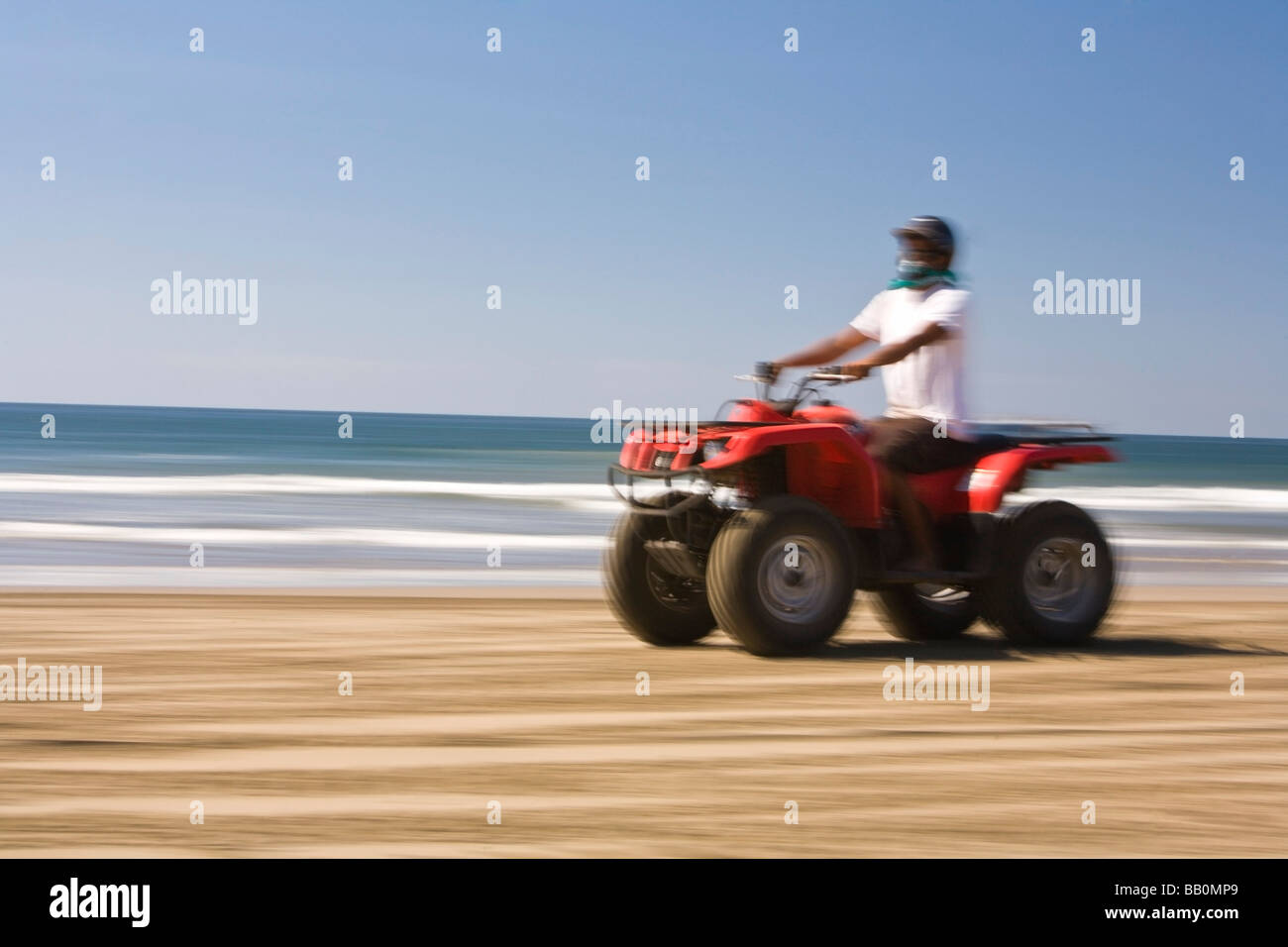 Man riding quad on sandy beach; Mazatlan, Sinaloa State, Mexico Stock ...