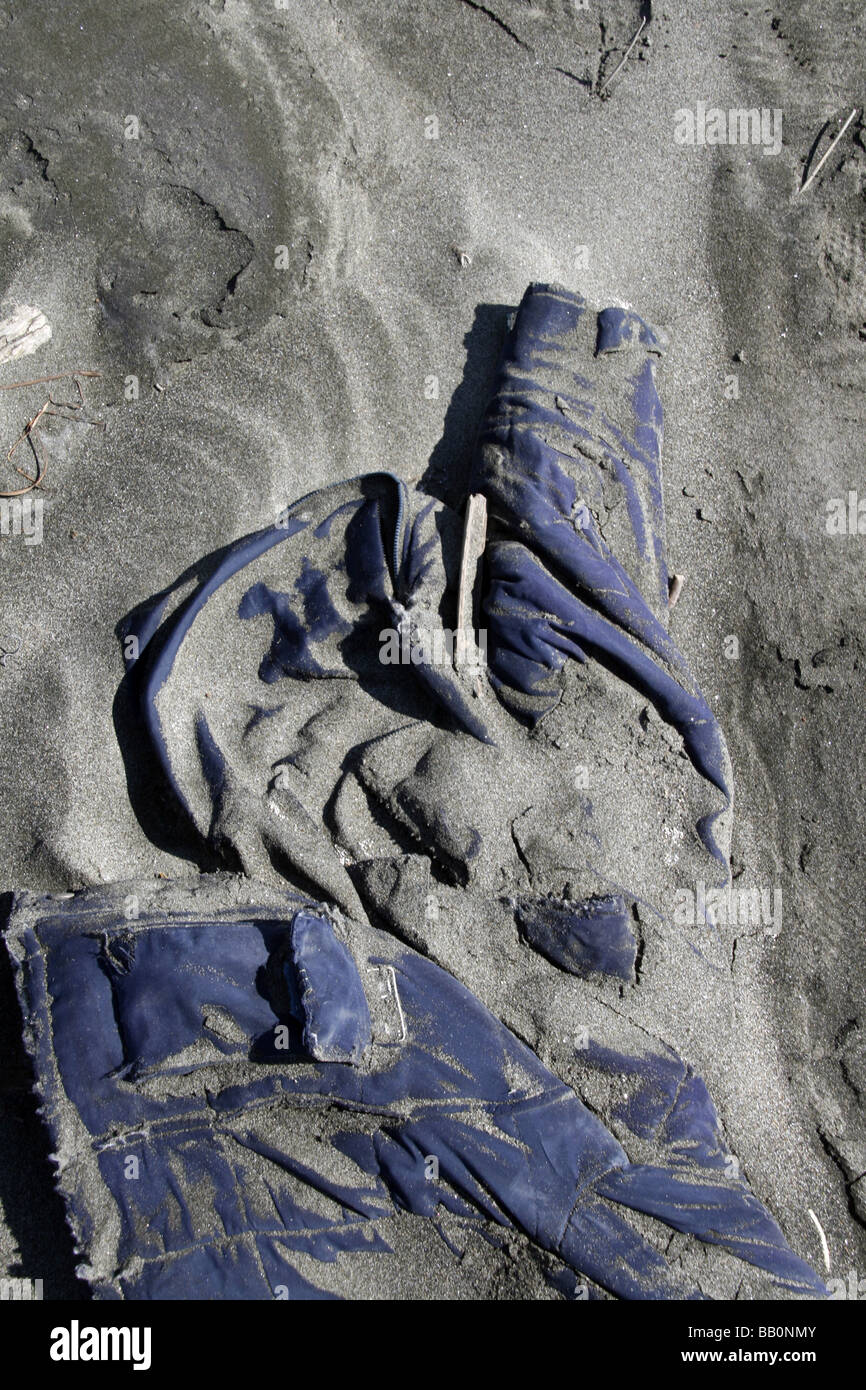 blue jacket washed up on beach Stock Photo - Alamy