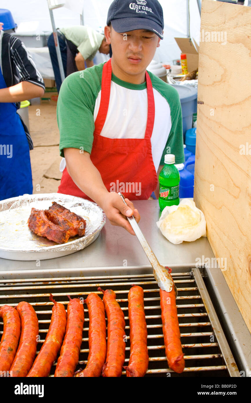 Hmong chef grilling extra long Asian sausage. Hmong Sports Festival ...