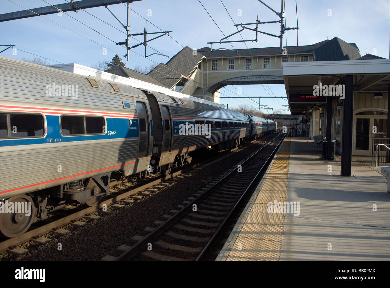 A commuter train drives at a Connecticut train station Stock Photo - Alamy