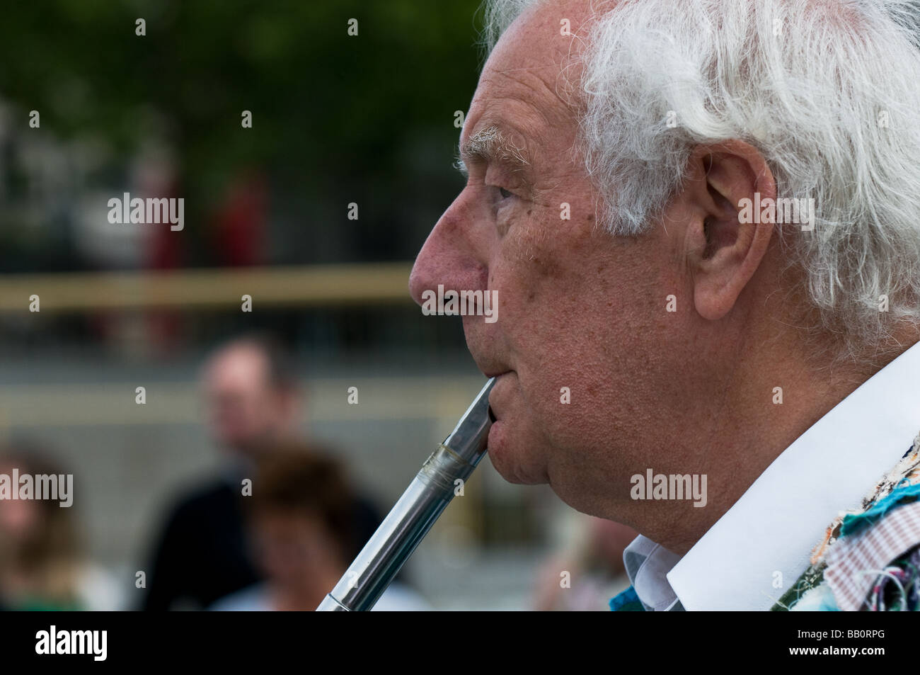 A man playing a tin whistle. Photo by Gordon Scammell Stock Photo - Alamy