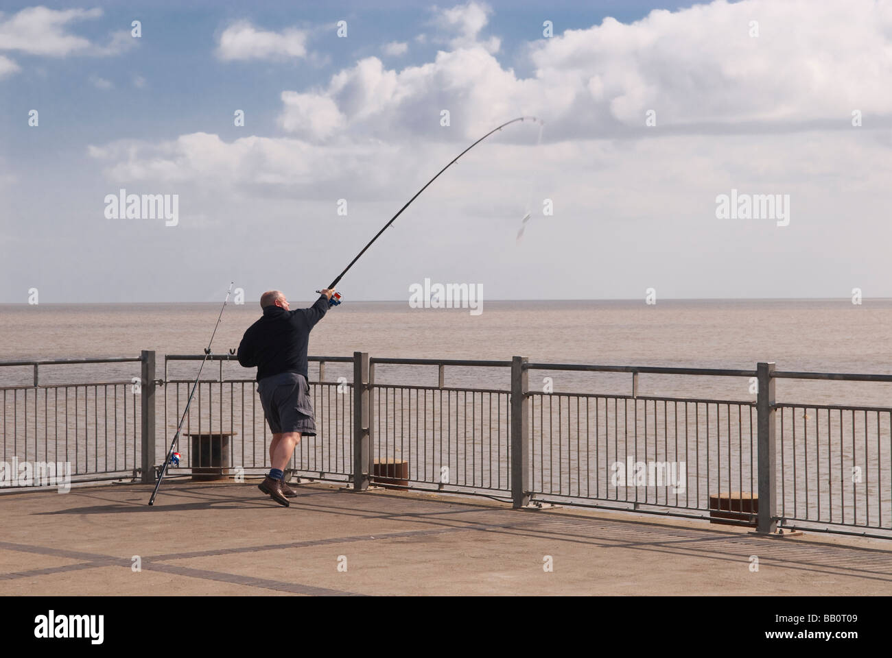 A man sea fishing off the end of Southwold Pier in Southwold,Suffolk,Uk ...