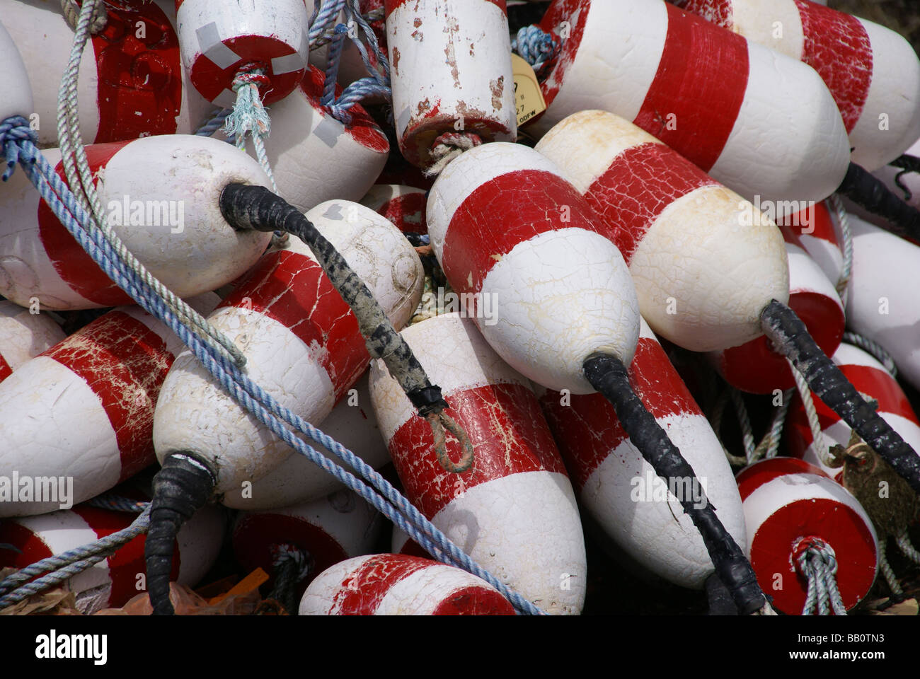 Red and white crab floats, drying on wharf Stock Photo - Alamy