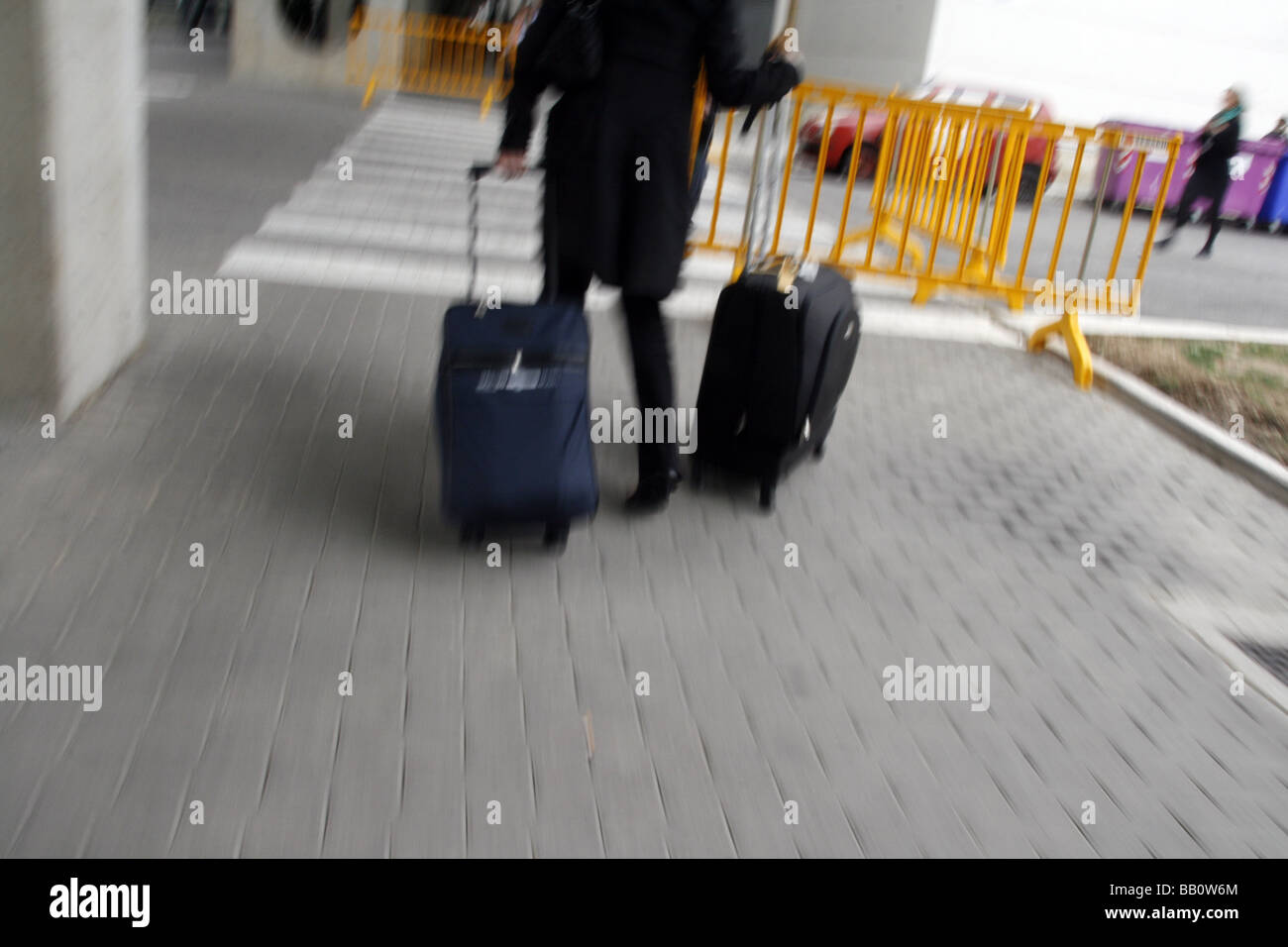 business person pulling trolley luggage case in town Stock Photo - Alamy