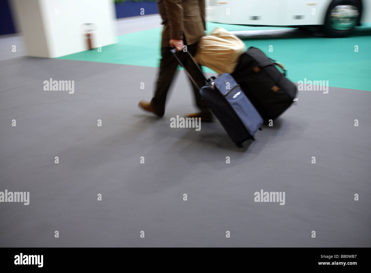 business man pulling trolley luggage case in conference centre Stock ...