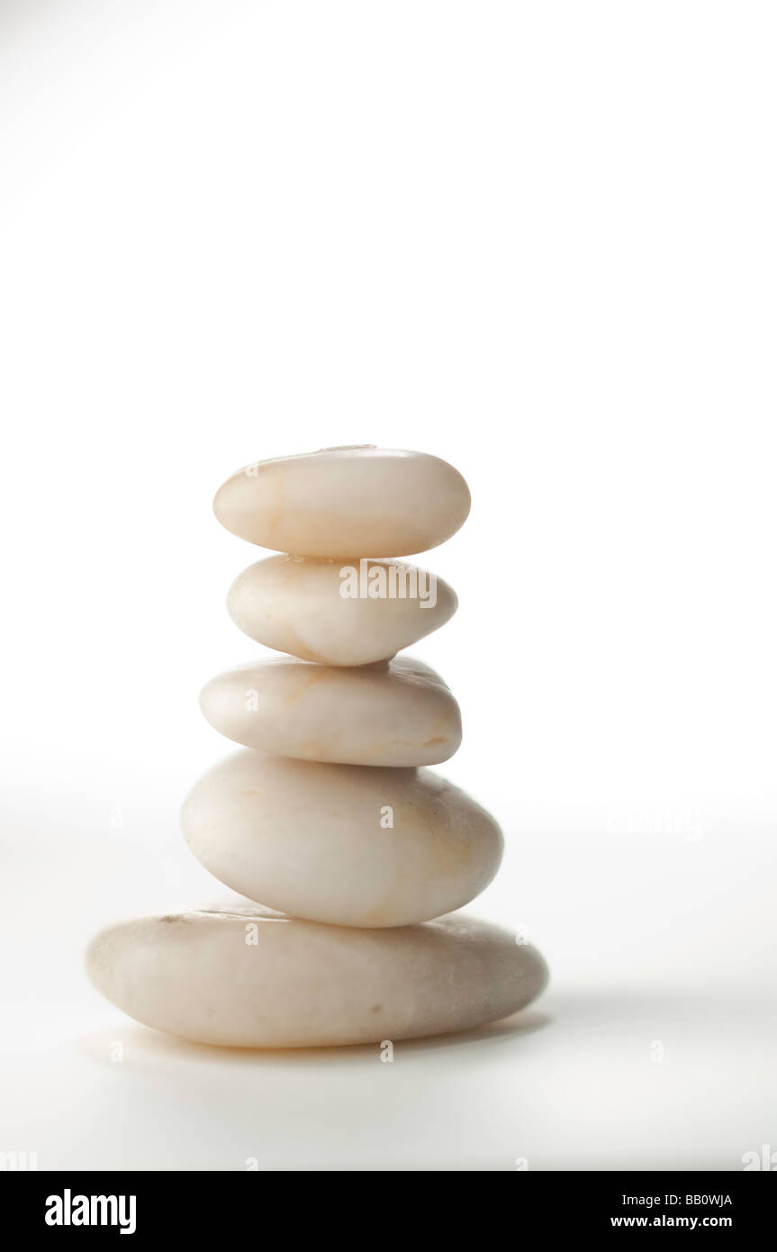 Balanced white rocks on white studio background Stock Photo - Alamy
