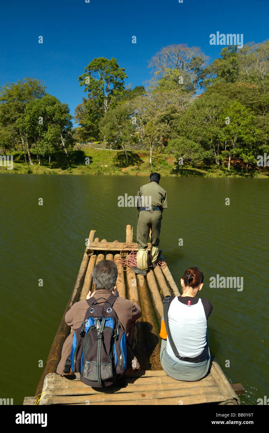 Two western tourists in the Periyar Tiger Reserve crossing the Periyar ...