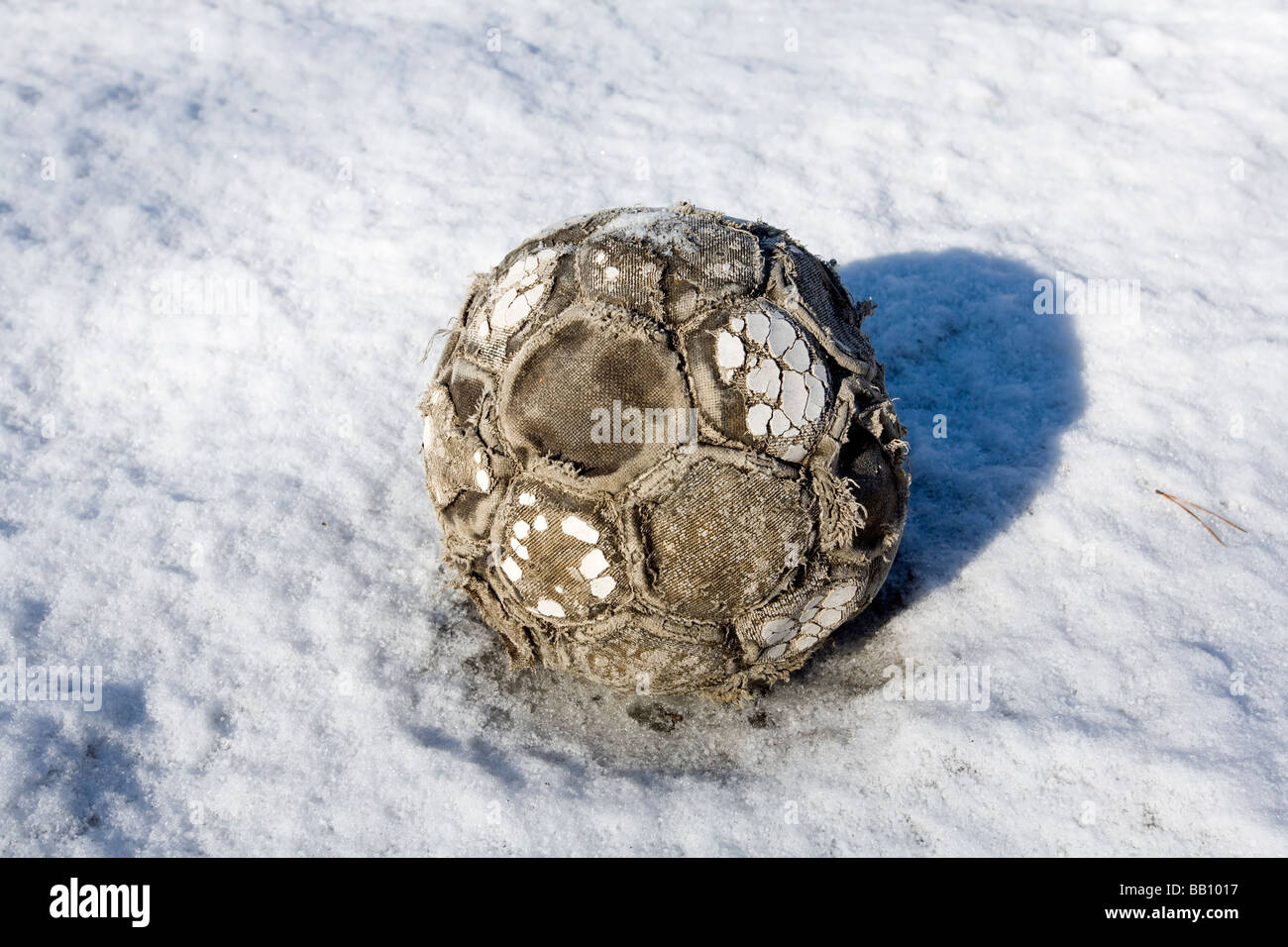 worn-out soccer ball on snow Stock Photo - Alamy