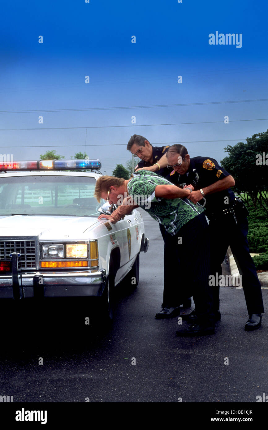 Police officers arrest a young man drunk driving with patrol car Stock ...