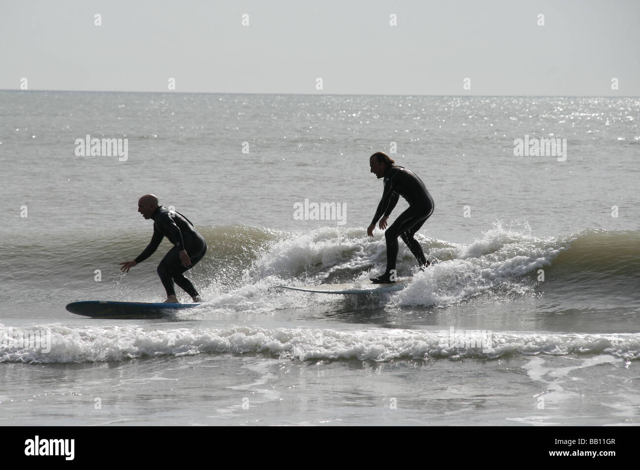 Two men wetsuits surfers hi-res stock photography and images - Alamy