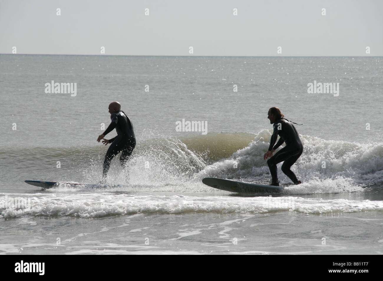 Two men wetsuits surfers hi-res stock photography and images - Alamy