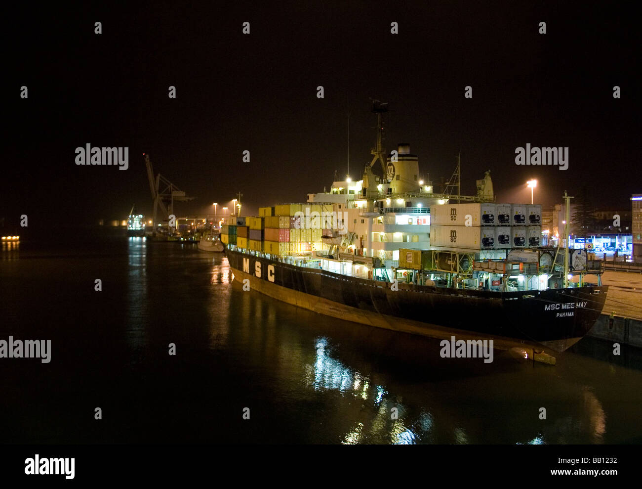 Port sending and receiving cargo via large freight ship Stock Photo - Alamy