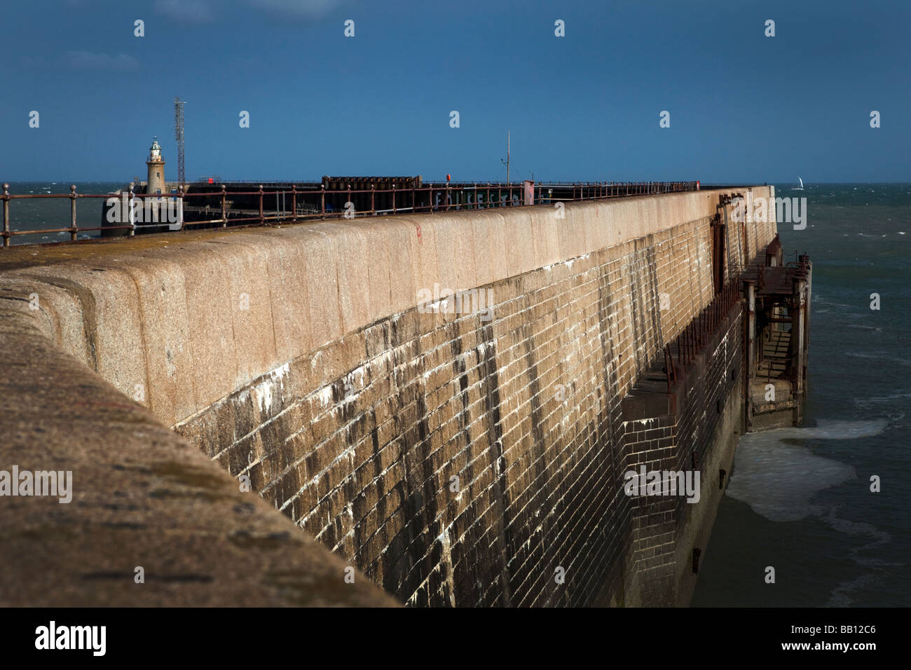 Folkestone pier, breakwater, showing the old lighthouse that marks the ...
