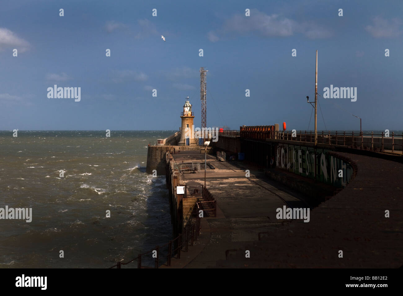The old lighthouse at the end of Folkestone pier, breakwater, marking ...
