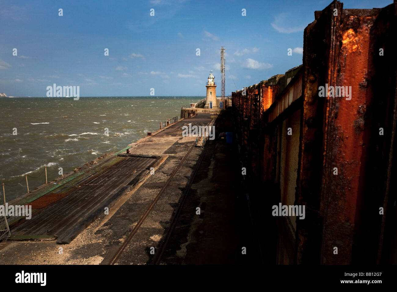 The old lighthouse at the end of Folkestone "pier", breakwater, marking ...