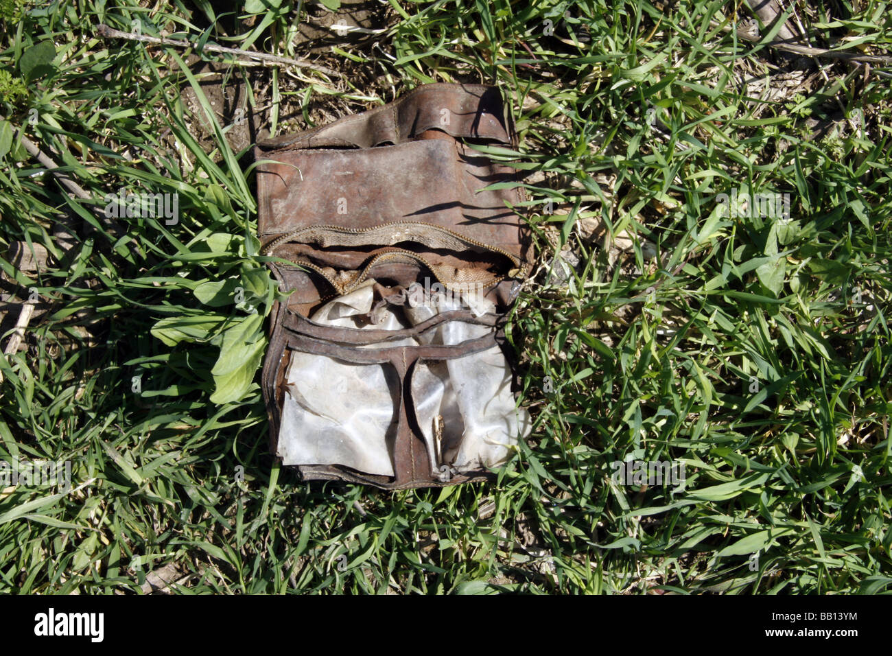 one old dirty damaged wallet left in field in country Stock Photo - Alamy