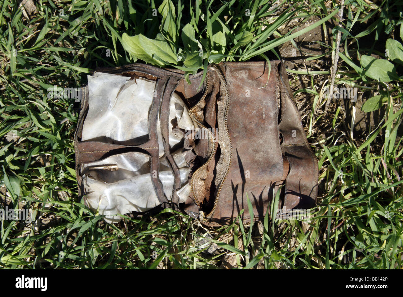 one old dirty damaged wallet left in field in country Stock Photo - Alamy