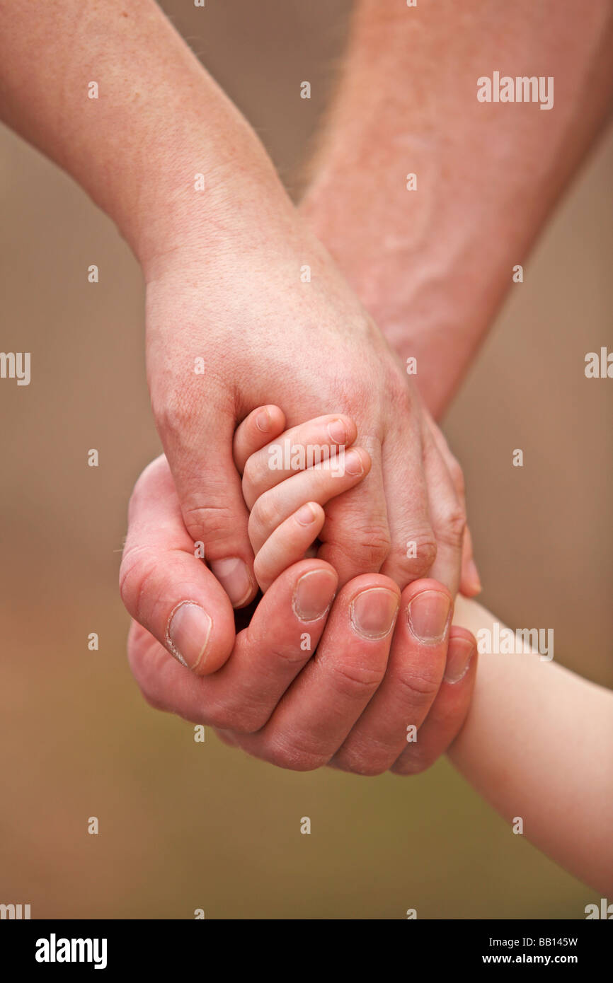 caring family hand clasp Stock Photo - Alamy