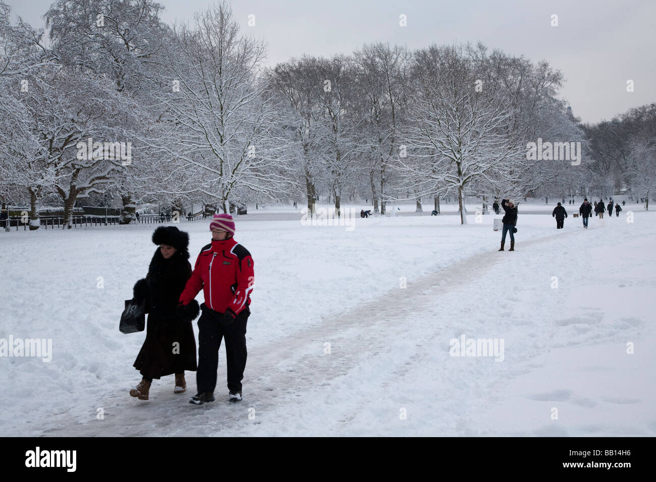 People walking through snow covered park, London Stock Photo - Alamy