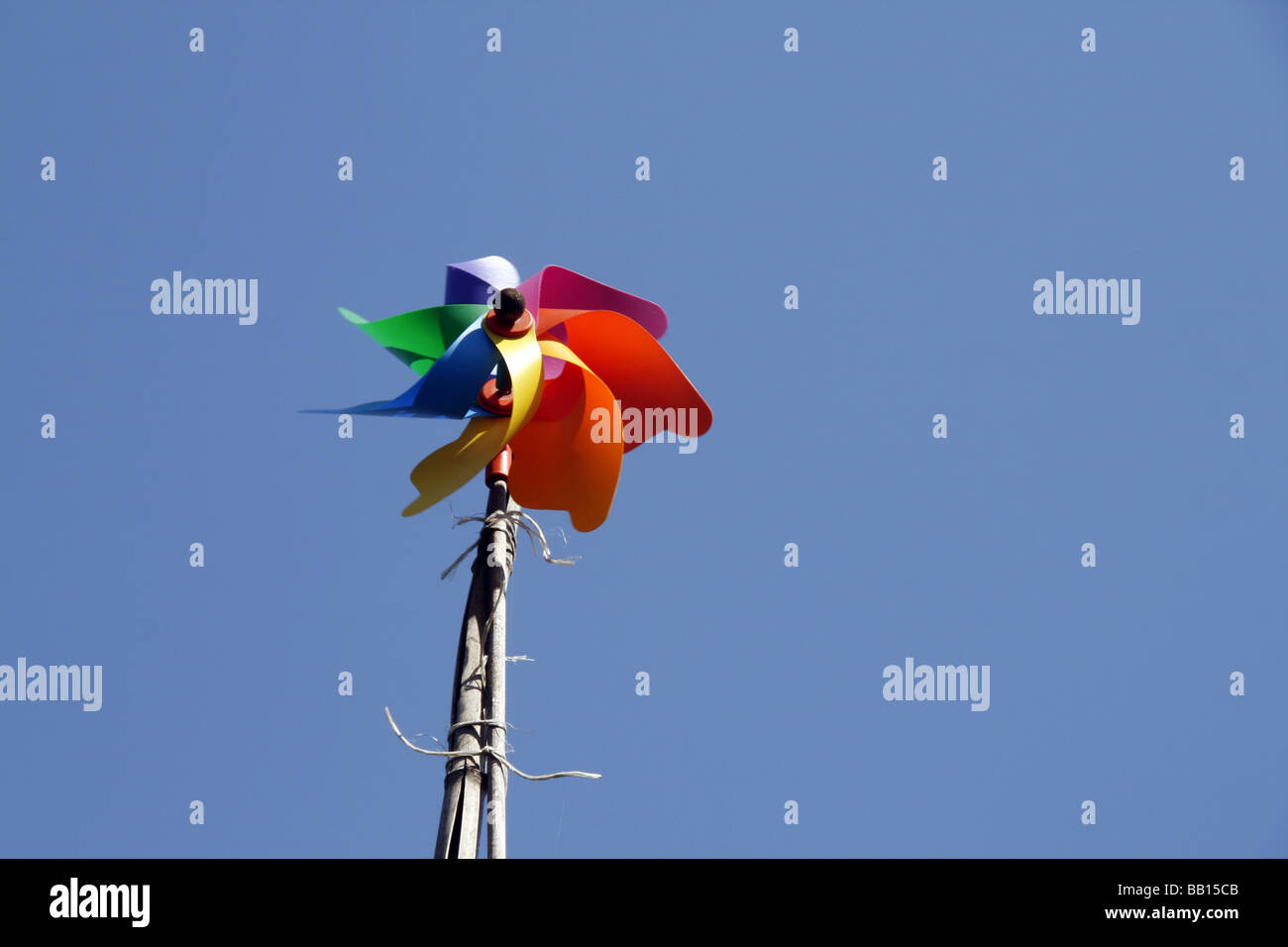 colourful windmill toy and blue sky outdoors in sun Stock Photo - Alamy