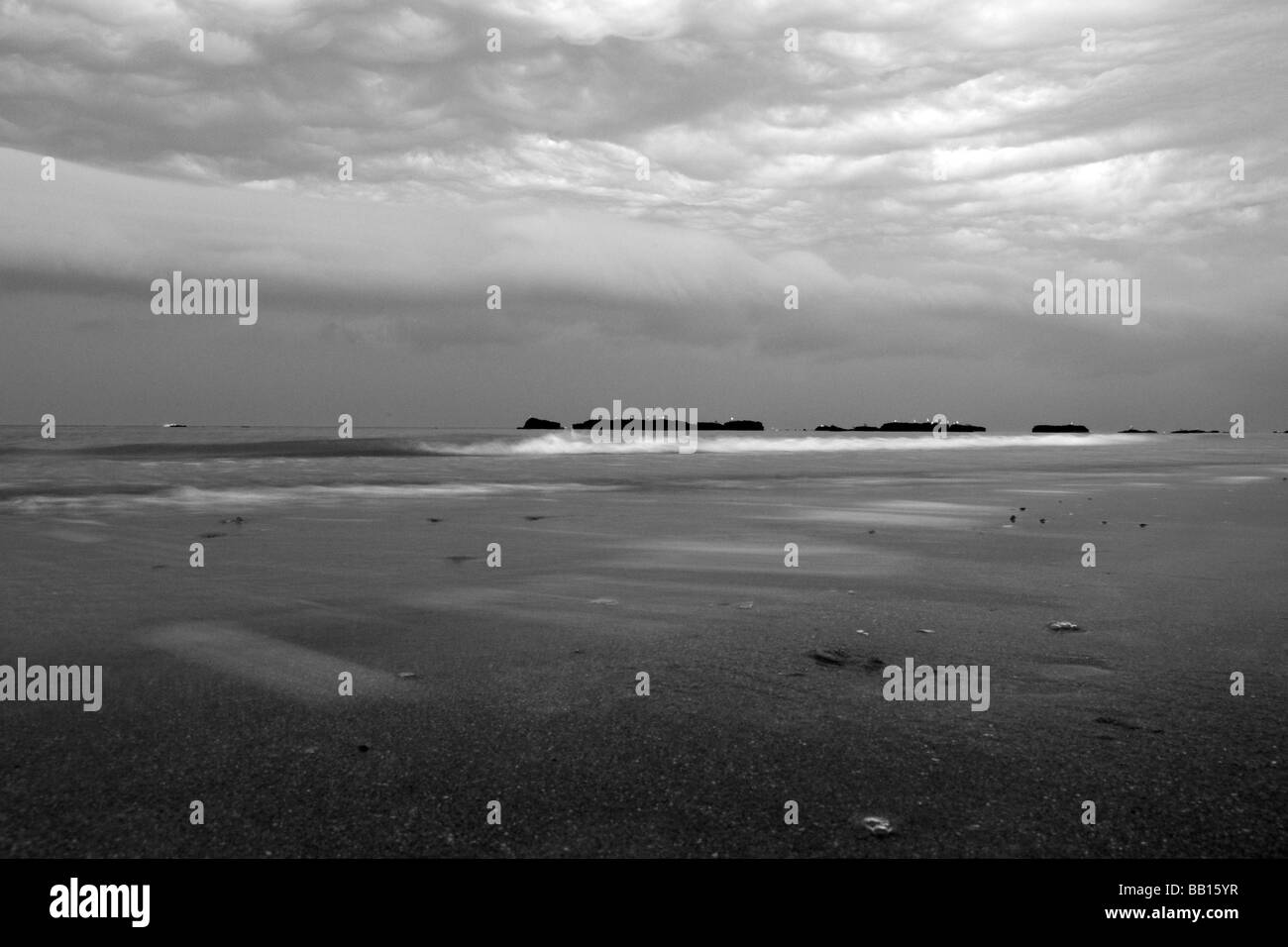 Beach scene, low tide and clouds Stock Photo - Alamy