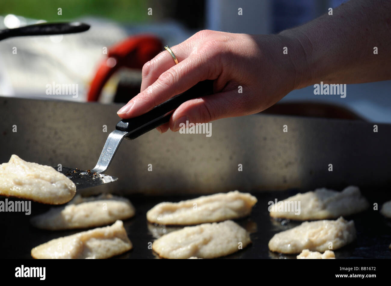 Cooking traditional jonnycakes on a griddle Stock Photo - Alamy